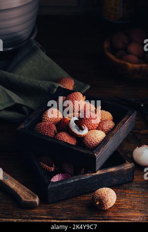 Delicious Fruits of Lychee in Rustic Box Stock Photo - Alamy