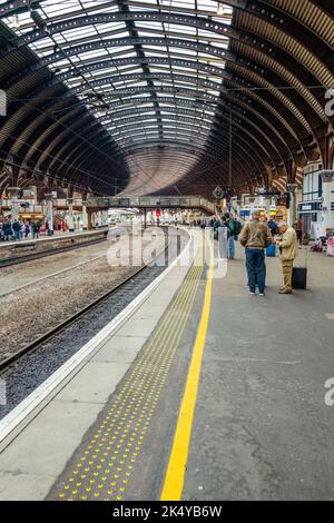 Passengers waiting on York railway station platform for the Azuma electric train Stock Photo - Alamy