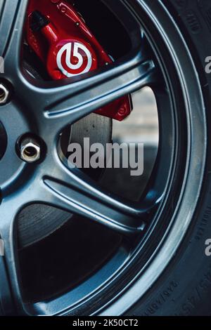 A vertical closeup of Blue Mitsubishi Evo VII logo detail Stock Photo ...