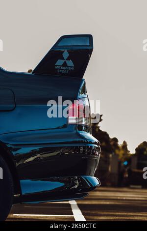 A vertical closeup of Blue Mitsubishi Evo VII wheel detail Stock Photo ...