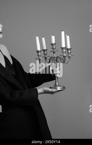 A vertical greyscale shot of an attractive female posing with a ...