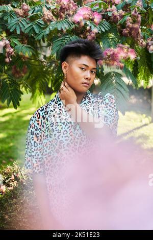 Asian non binary person without makeup looking at camera and making ...