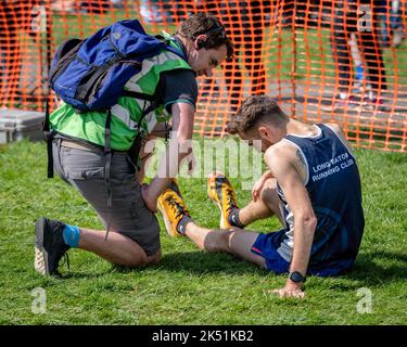 Collapsed half-marathon male runner receiving paramedic aid treatment ...