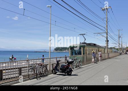 the train of Enoshima Electric Railway is passing the level crossing ...
