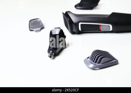 Defocus electric clipper with different set on white background ...