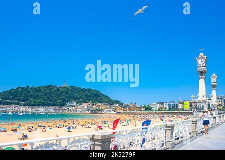 Nice beach with the old town of San Sebastian, Spain at gorgeous sunset ...