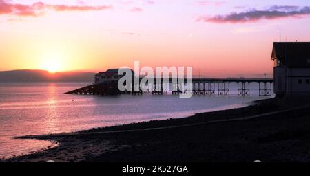 Mumbles lifeboat station at sunrise. The original red and white ...