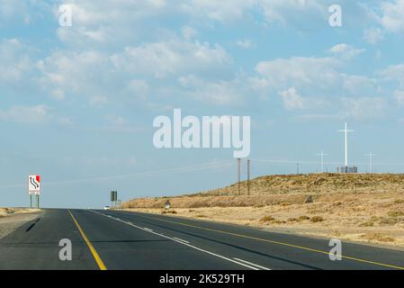 Road N1 at Trompsburg. A road sign, power route and three crosses on a ...
