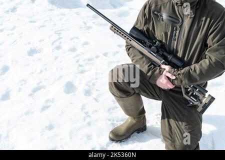A sniper rifles from a rifle with an optical sight in man`s hands sunny ...