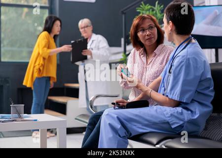 Nurse doing insulin level measurement with instrument to help elderly ...