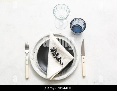 Elegant table setting on light wooden background Stock Photo - Alamy