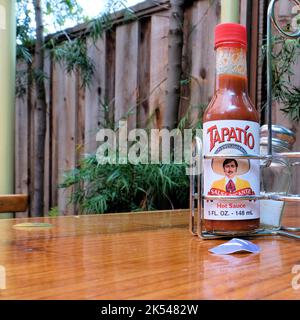 Tapatio hot sauce bottle and salt shaker in a metal condiment caddy on ...
