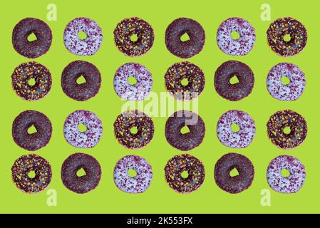 Top view to the donuts over green background Stock Photo - Alamy