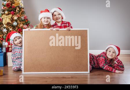 Four children indoors with empty banner on Christmas holiday Stock ...