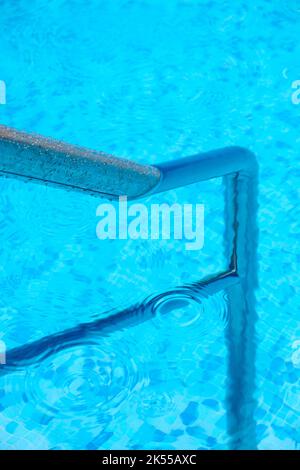 Entering a swimming pool with deep blue water Stock Photo - Alamy