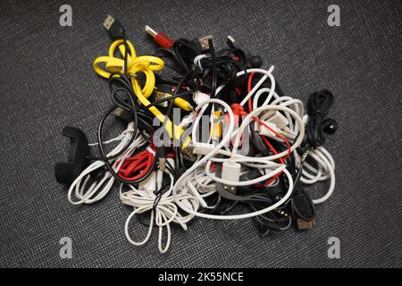 tangled cables of different types on a black background Stock Photo - Alamy
