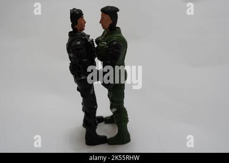two soldier figurines arguing concept. armymen in green combat uniform ...