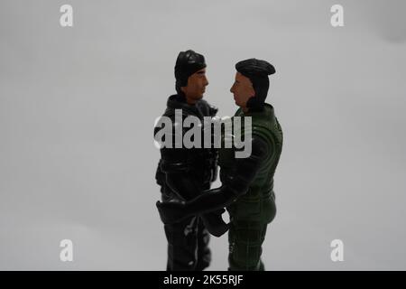 two soldier figurines arguing concept. armymen in green combat uniform ...