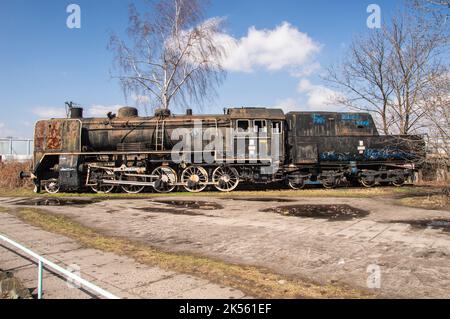 An old and dilapidated historic PKP steam locomotive standing on a ...