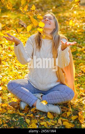young woman throw leaves in a park in autumn Stock Photo - Alamy