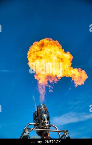 fire ball agaisnt blue sky from a ballon burner Stock Photo - Alamy