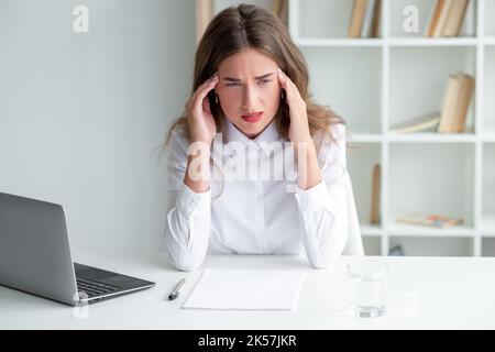 Exhausted of hard work business lady sitting in office among papers ...
