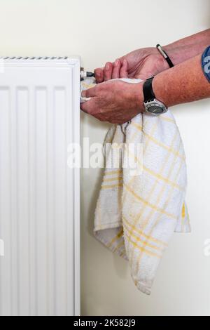 Bleeding a radiator valve to release any trapped air and ensure the ...