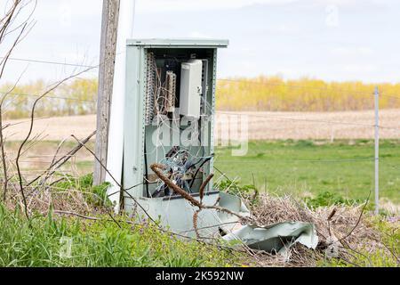 Telephone pedestal junction box damaged with exposed wires in ditch ...