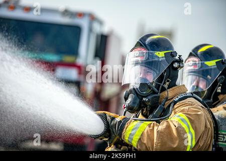 Firefighters from the 422d Fire Emergency Services extinguish an ...