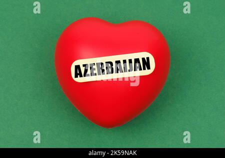 Love to motherland. On a green surface lies a red heart with the ...