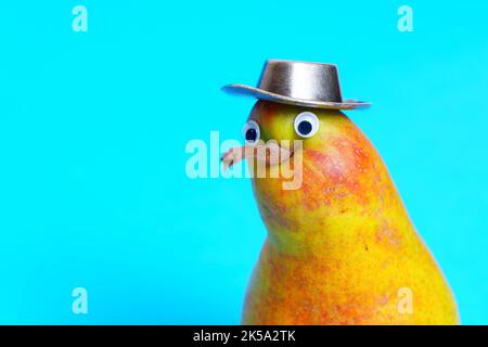 Close-up of a cute anthropomorphic pear with googly eyes wearing a ...