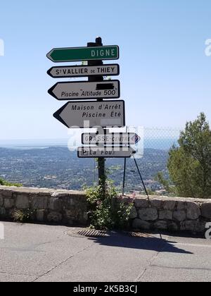 A vertical shot of a street sign tablet with stickers on it in ...