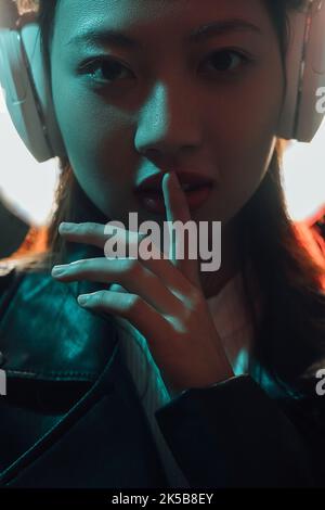 Female secret. Neon light portrait. Keep quiet. Happy relaxed smiling ...