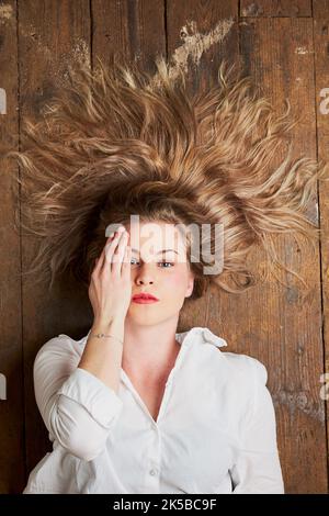Female model laying down on wood floor Stock Photo - Alamy