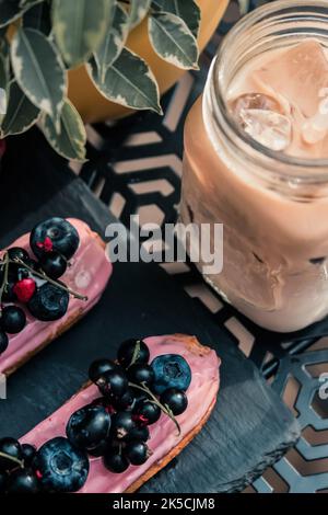 Yummy French eclairs on pink background Stock Photo - Alamy