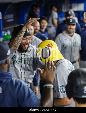 Seattle Mariners' Cal Raleigh, right, celebrates with third base coach ...