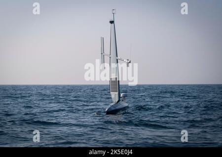 A U.S. Navy Saildrone Explorer unmanned surface vessel remotely sails ...