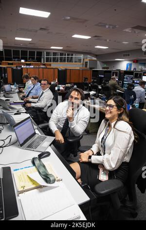 Members of the Artemis I launch team are at their consoles inside ...