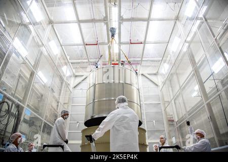Technicians lower the payload adapter separation systems canister for ...