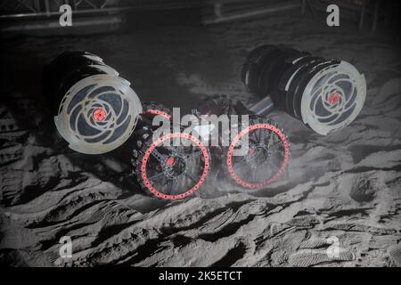 The ISRU Pilot Excavator digs in the regolith bin during testing inside ...