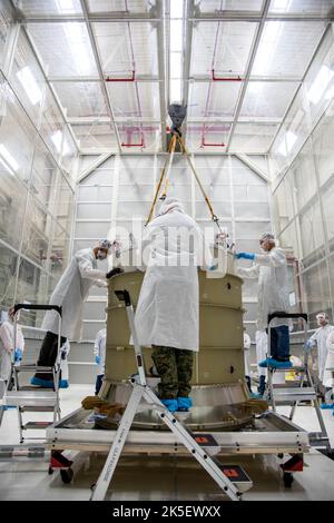 Technicians lower the payload adapter separation systems canister for ...