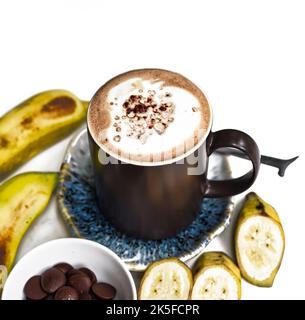 Banana chocolate latte with fresh banana and chocolate drops on white ...