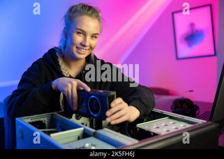 Smiling E-sport Gamer Girl Installing New GPU Video Card in Her Gaming ...