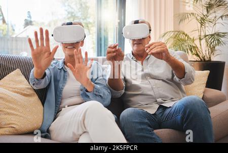 Aged female in futuristic glasses standing under neon illumination in ...