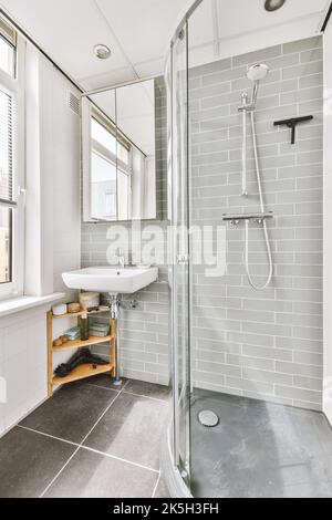 Sinks with mirrors and shower box with glass door in modern bathroom ...