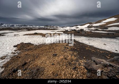 Snow-covered volcanic landscape with tuff and petrified lava, crater of ...