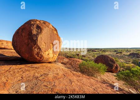 Balanced round eroded granite boulder at Devil's Marbles, a popular ...