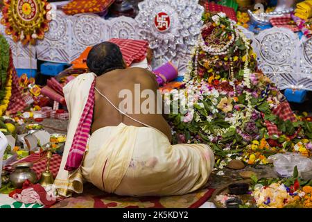 puja rituals being performed by hindu priest with flowers and other ...