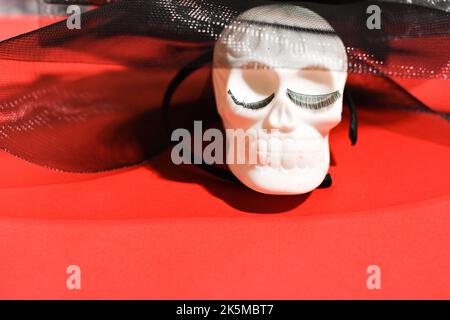 Cheerful Human skull with eyelashes on a red background Stock Photo - Alamy