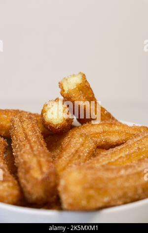 close up of churros with sugar in white bowl, top view Stock Photo - Alamy